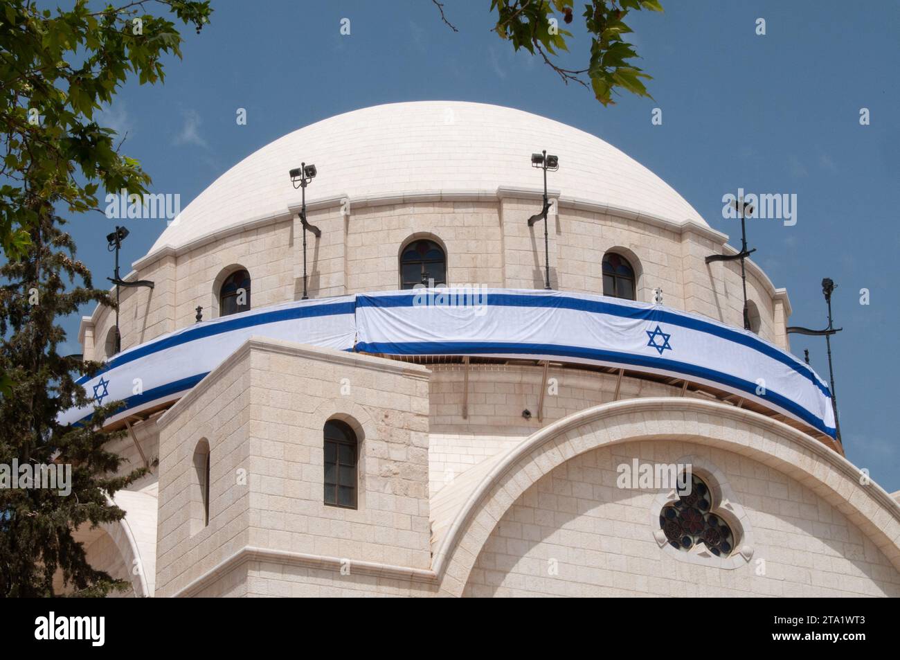 A large, elongated, blue and white flag of the State of Israel draped ...
