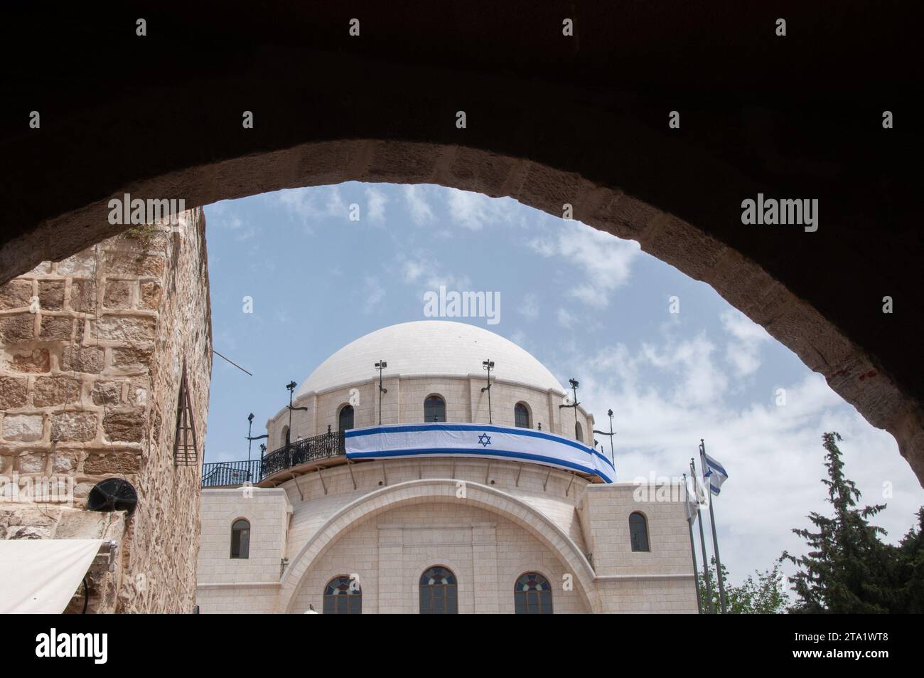 A large, elongated, blue and white flag of the State of Israel draped ...
