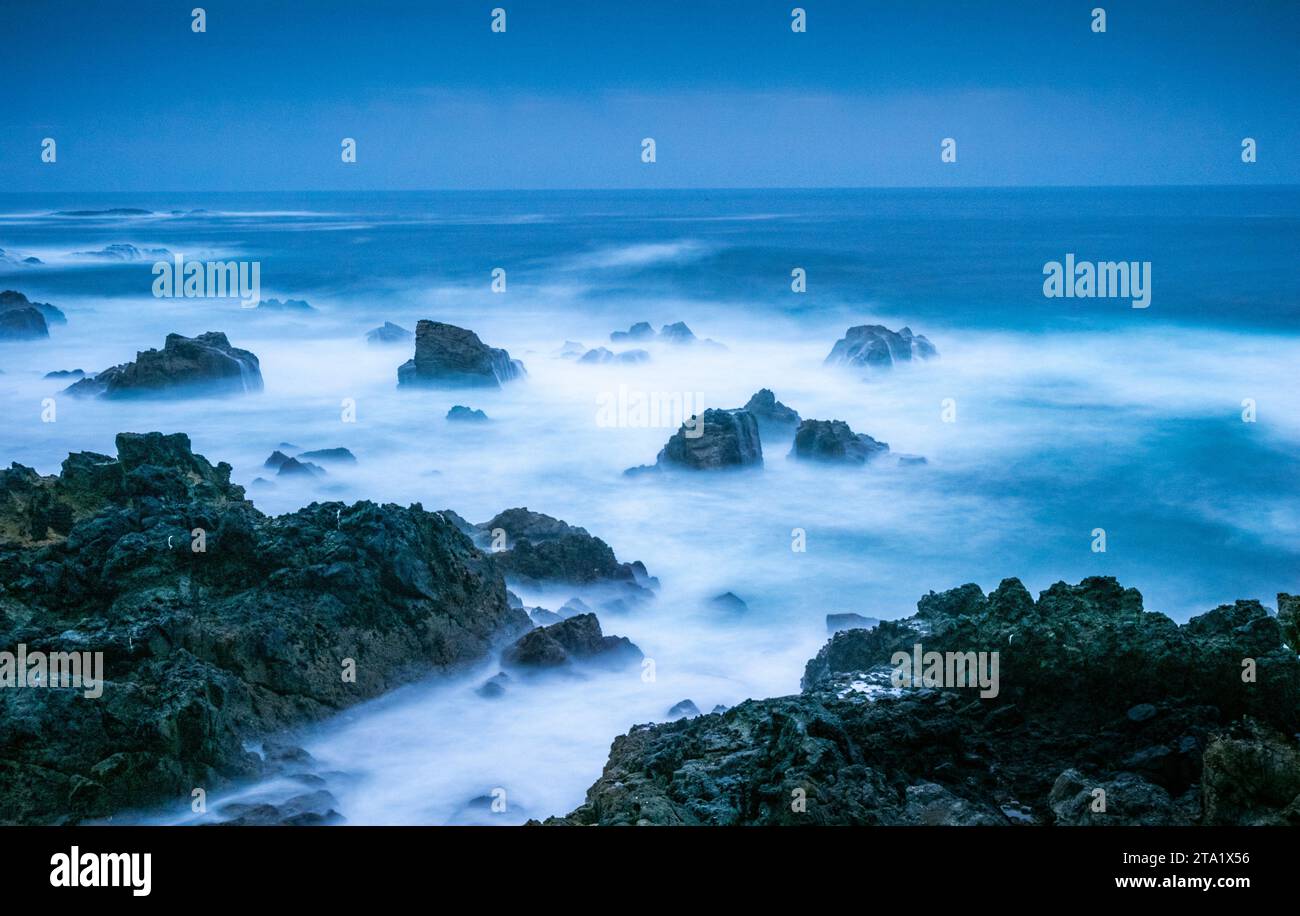 Dusk along the rocky shoreline of the Atlantic Ocean in the Costa Azul ...