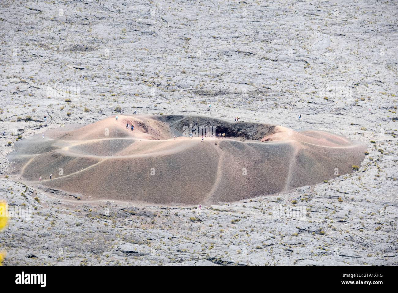 Hikers on an ancient crater of the Piton de la Fournaise volcano ...