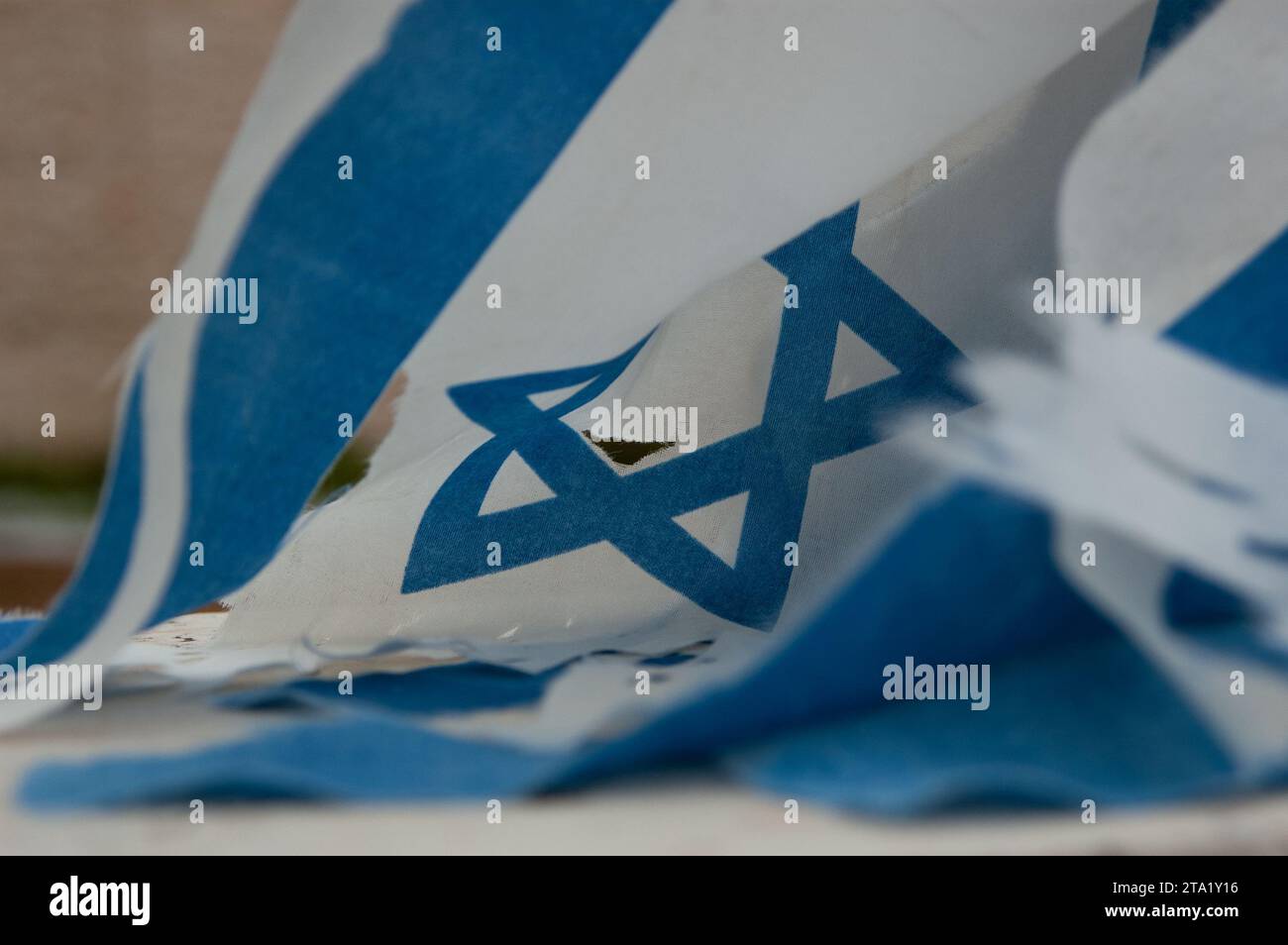 Closeup of the blue Star of David on a dirty, torn and shredded flag of ...
