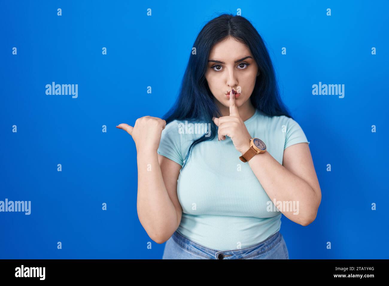 Young Modern Girl With Blue Hair Standing Over Blue Background Asking 1829