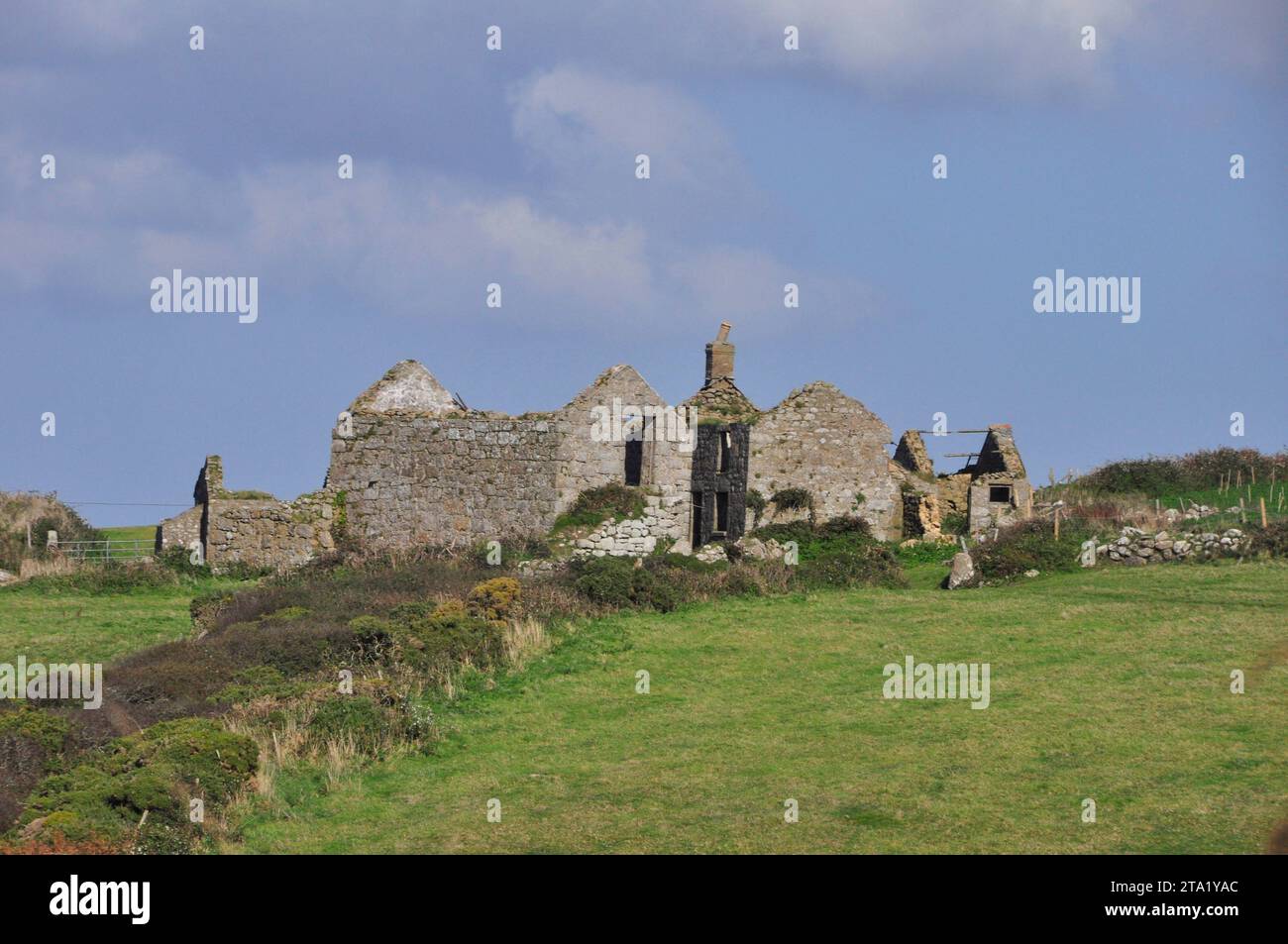 The ruins of an abandoned farm in the fields on the top of cliffs near ...