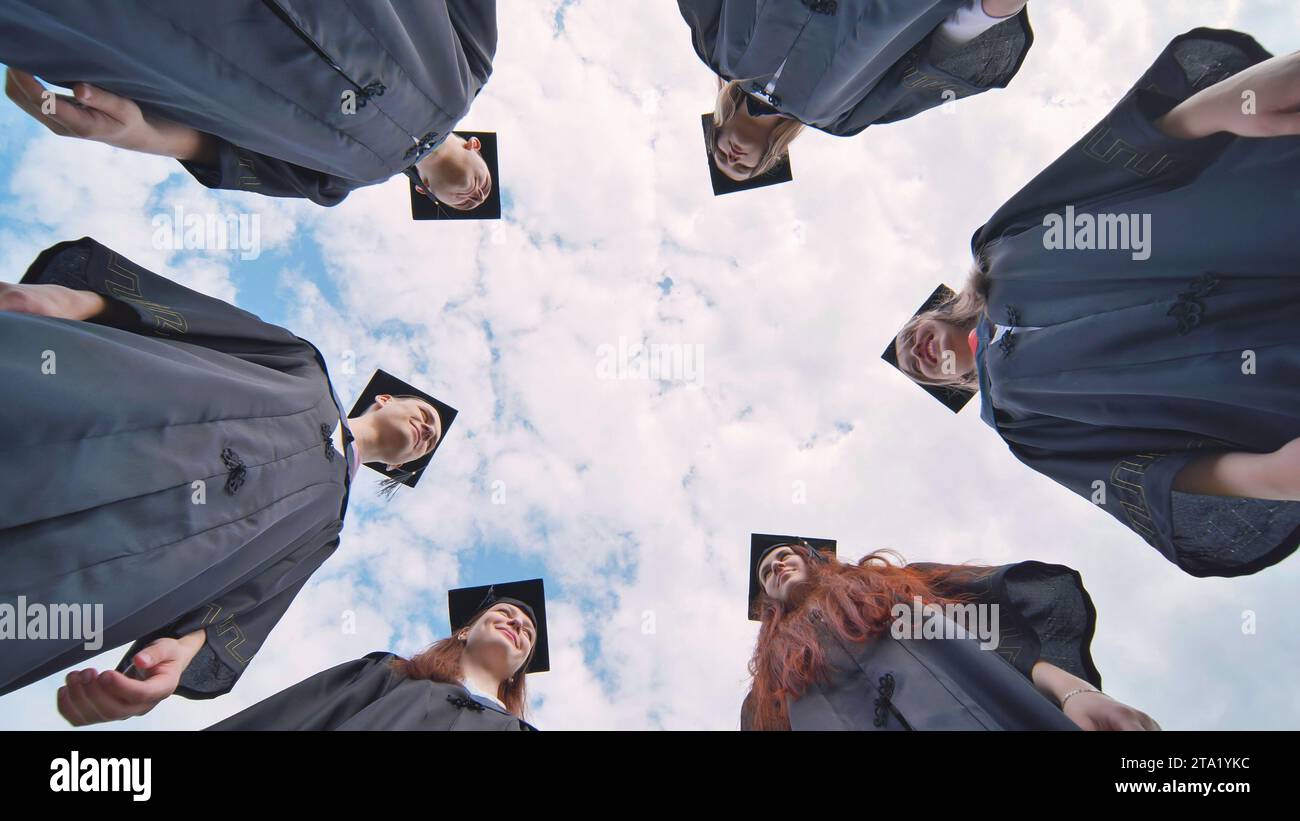 College students stand in a circle wearing black robes Stock Photo - Alamy