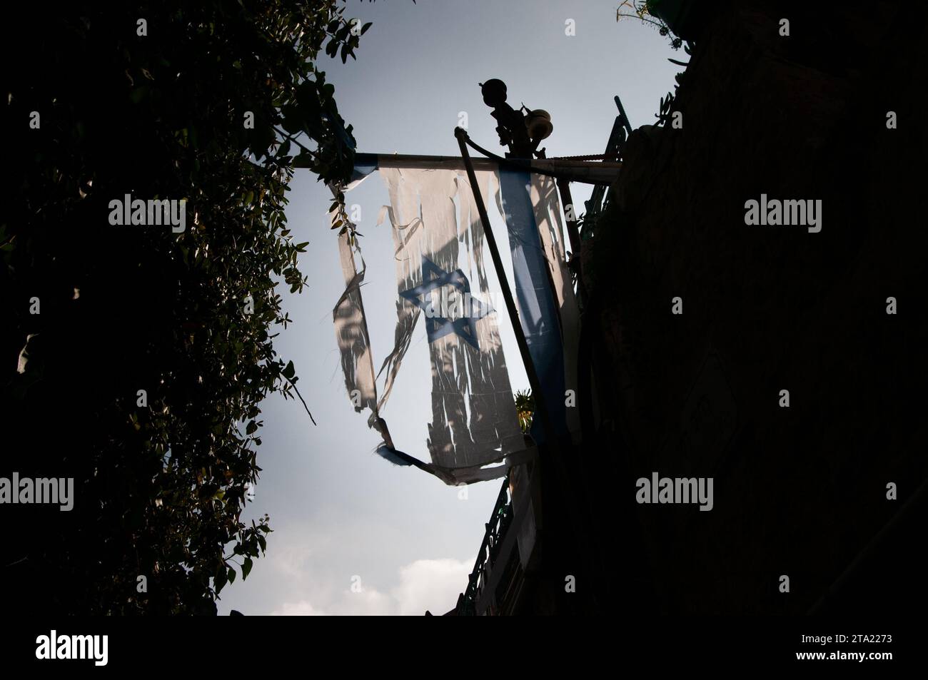 Worn and weathered, torn and tattered Israeli flag attached to a ...