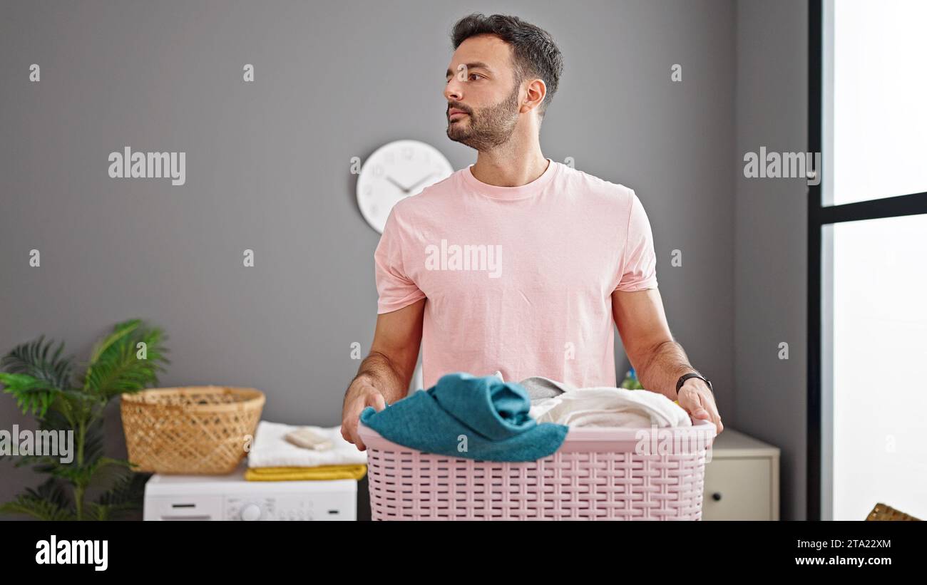 Hispanic man holding laundry hi-res stock photography and images - Alamy