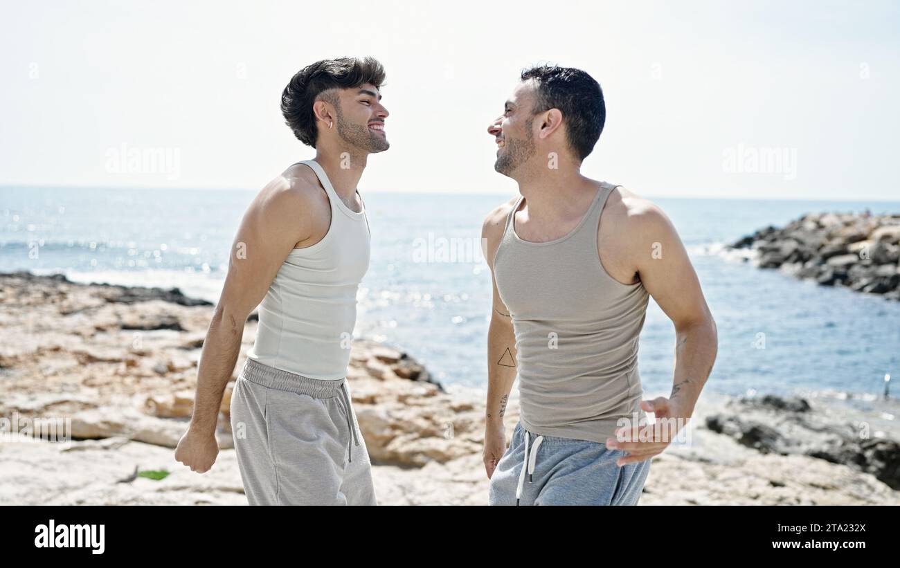 Two men couple smiling confident dancing at seaside Stock Photo - Alamy