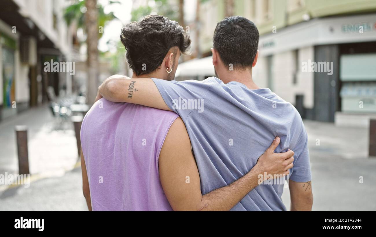 Two men couple hugging each other backwards at street Stock Photo - Alamy