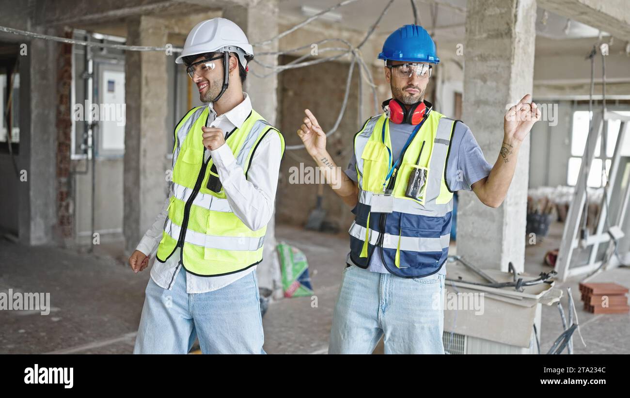 Two men builders smiling confident dancing at construction site Stock ...