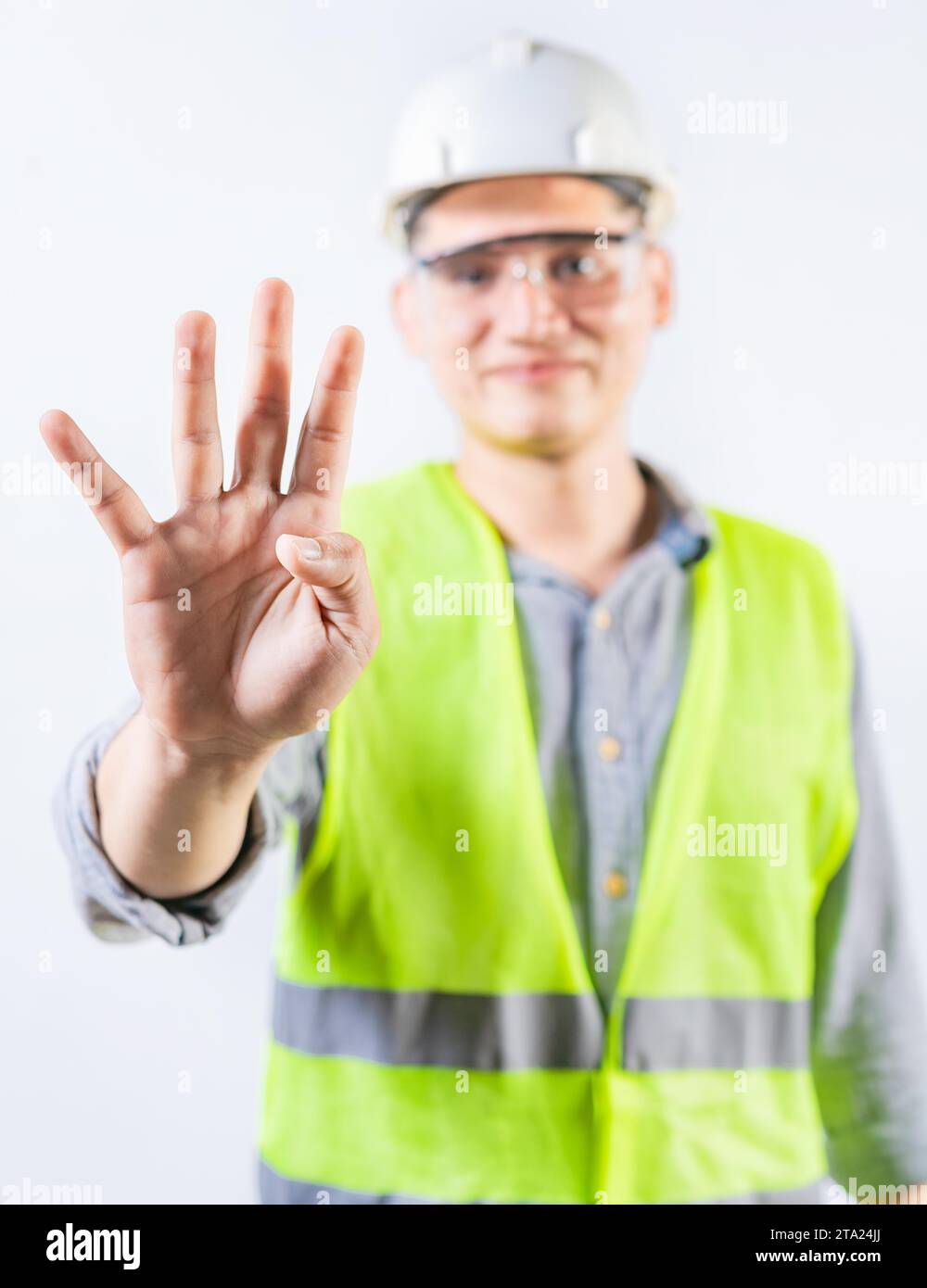 Young engineer counting number four isolated. Male engineer showing ...