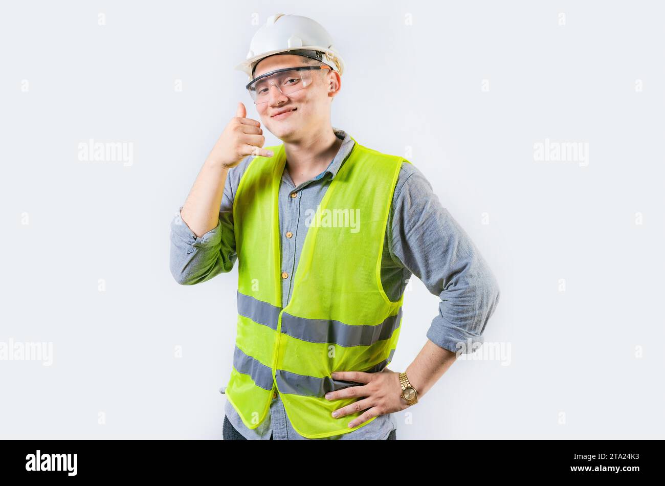 Portrait of young engineer making call gesture isolated. Handsome ...