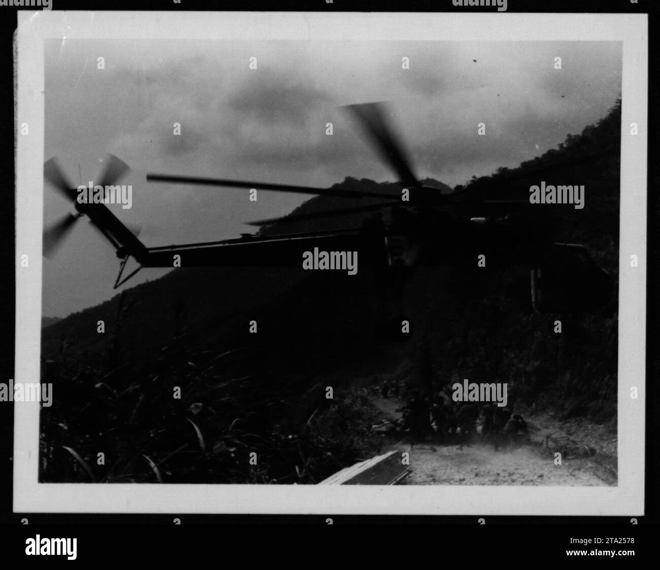 A fleet of CH-54 helicopters departing from a military base during the ...
