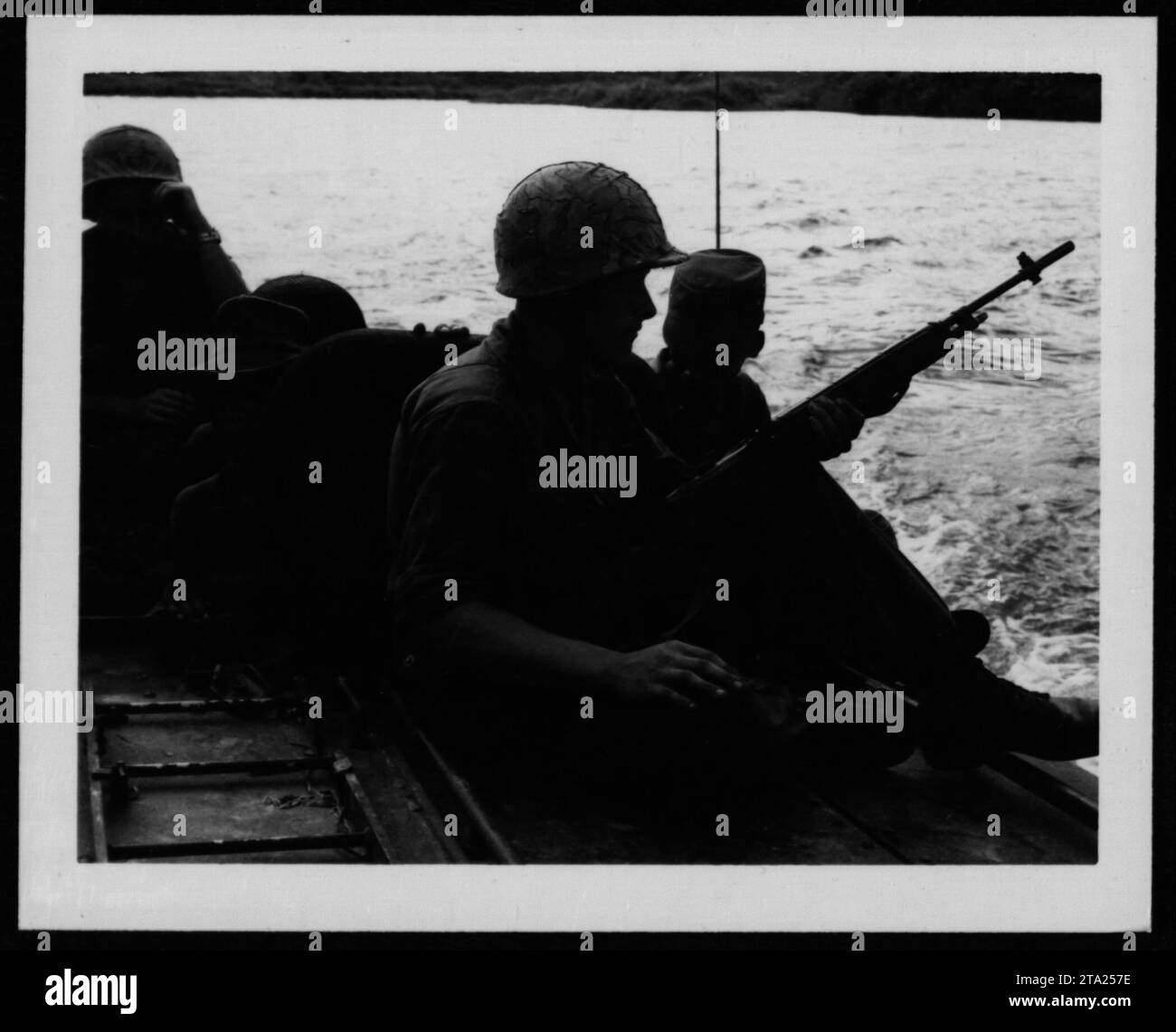 American soldiers engage in combat during the Vietnam War. The image ...