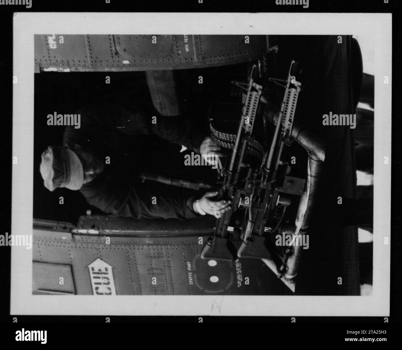 Military personnel perform maintenance checks on helicopters including ...