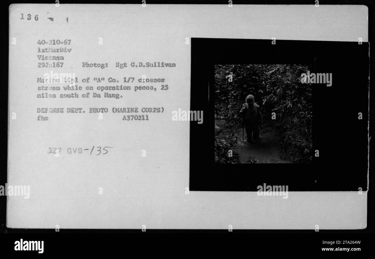 Marine LCpl from "A" Co. 1/7 crosses a stream during Operation Pecos ...