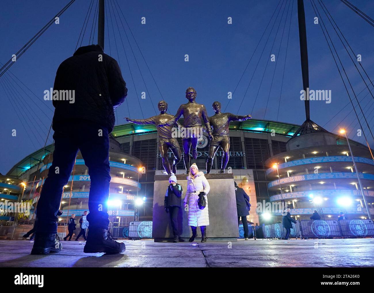 Manchester, UK. 28th Nov, 2023. Fans pose next to the newly unveiled ...