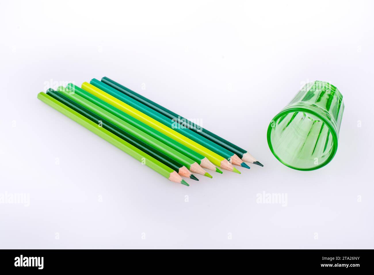 Color Pencils and a green glass on a white background Stock Photo - Alamy