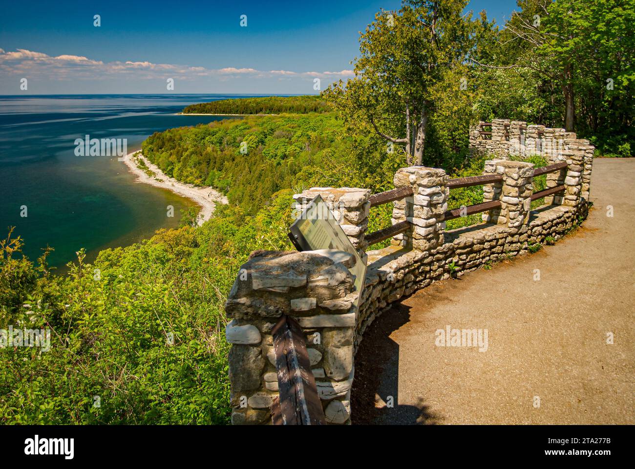 Green Bay and line of clouds with spring forest colors are seen from ...