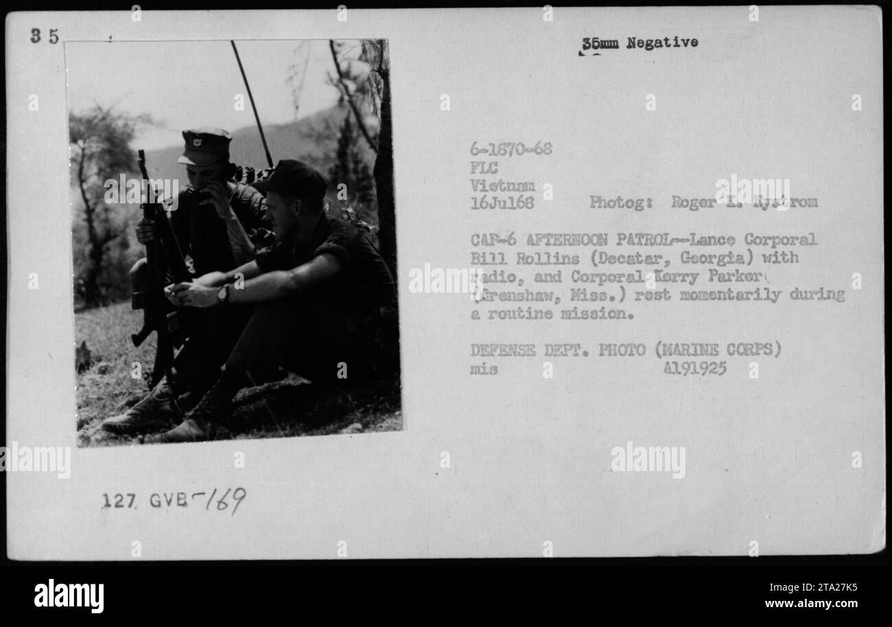 Photograph shows Lance Corporal Bill Rollins carrying a radio while ...