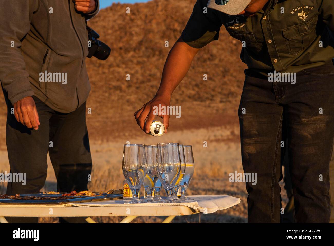 Guide prepares sundowner drink, Namib Desert, Namib Desert, Namibia ...