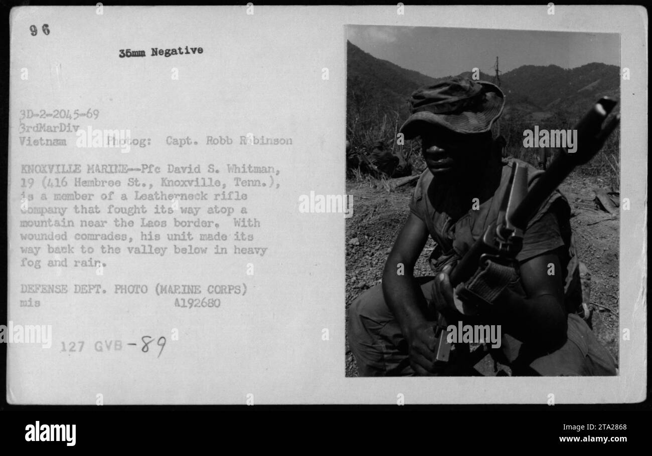 Caption: Pfc. David S. Whitman, a member of a Leatherneck rifle company ...