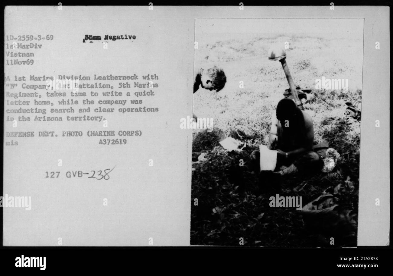 A member of the 1st Marine Division writes a letter home during search ...