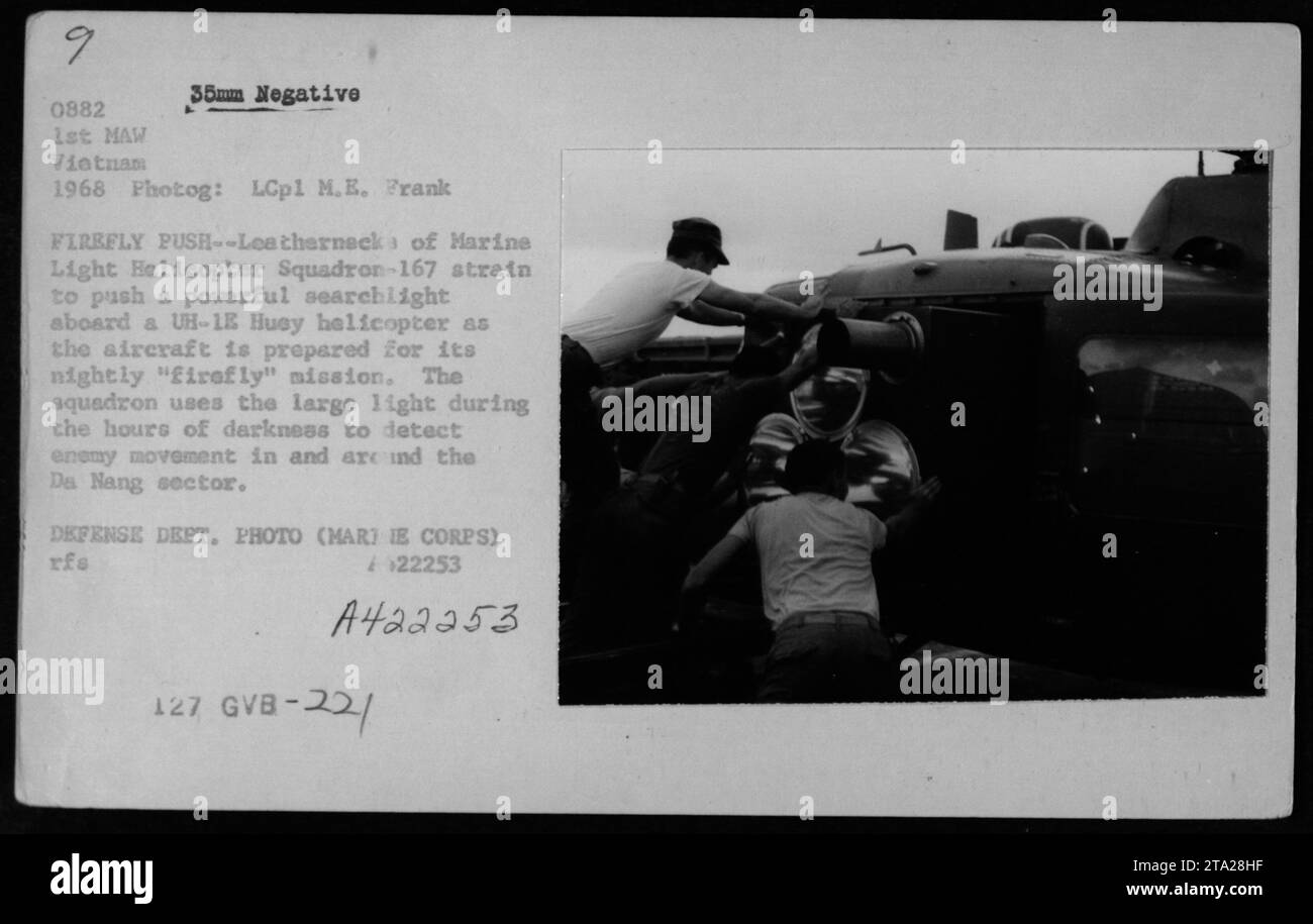 US Marines from Marine Light Helicopter Squadron-167 are seen pushing a ...