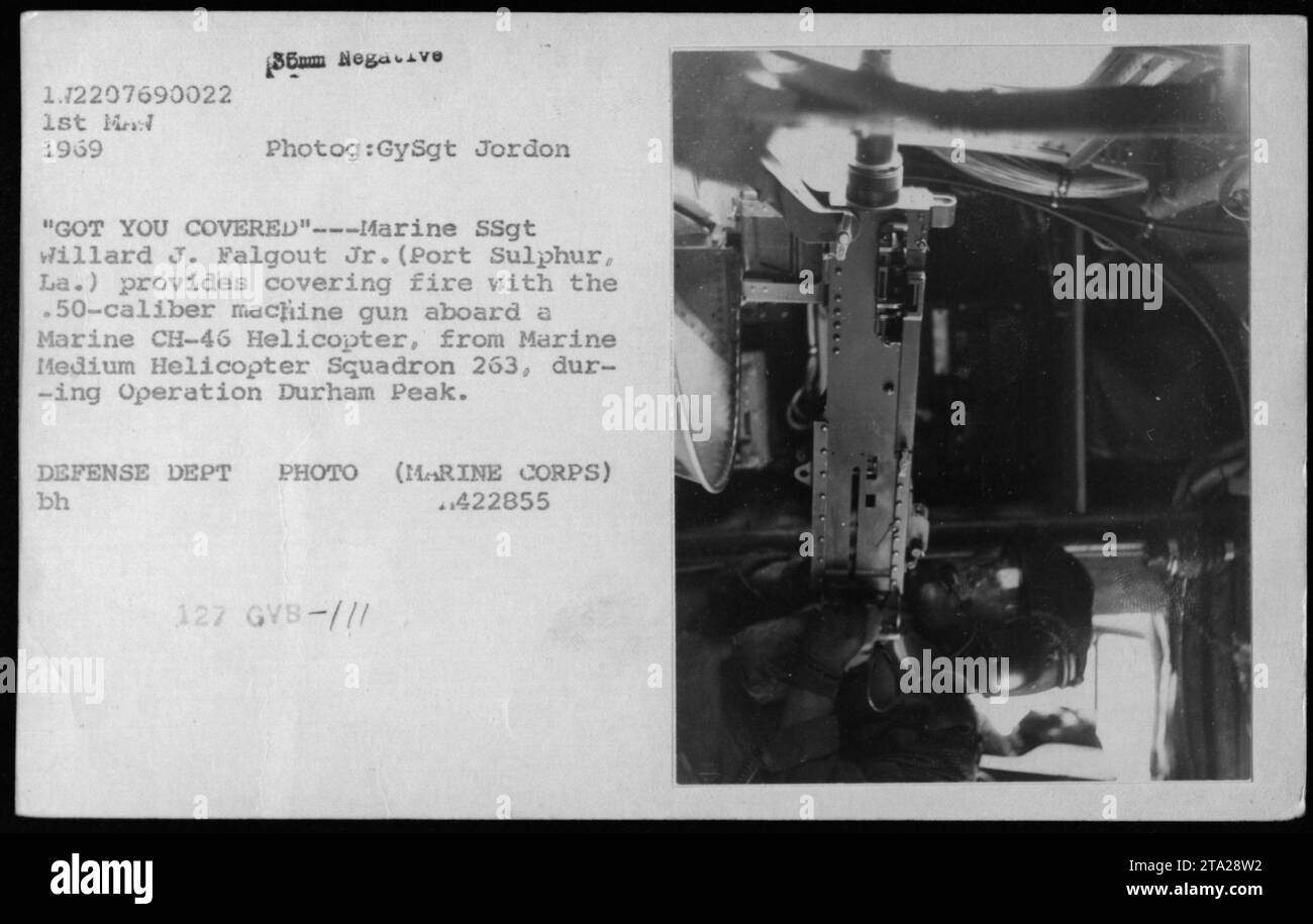 Marine SSgt Willard J. Falgout Jr. provides covering fire with a .50 ...