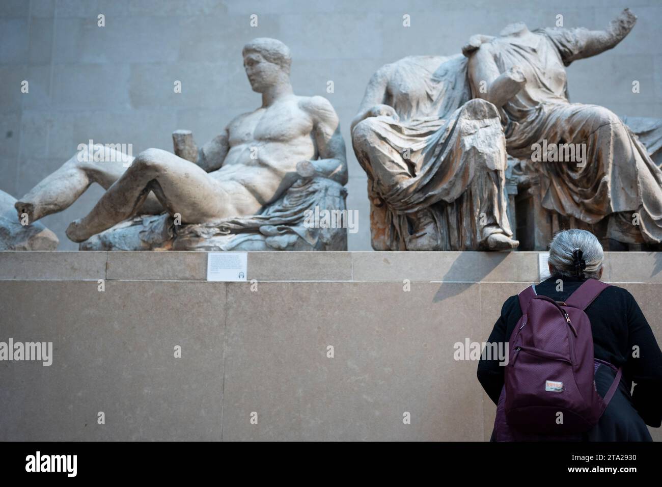 Visitors in London's British Museum admire the horse's head, one of the ...