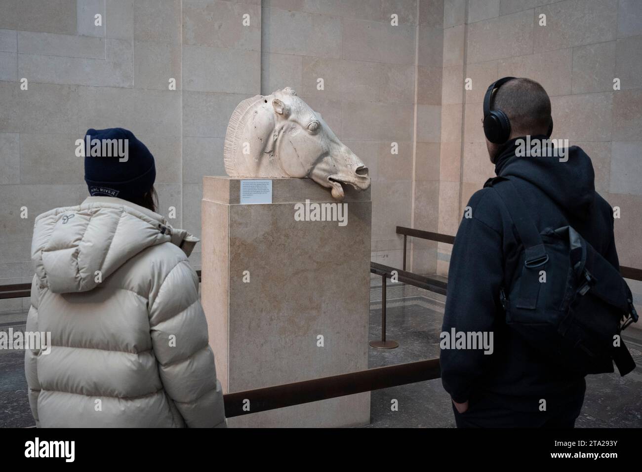 Visitors in London's British Museum admire the horse's head, one of the ...
