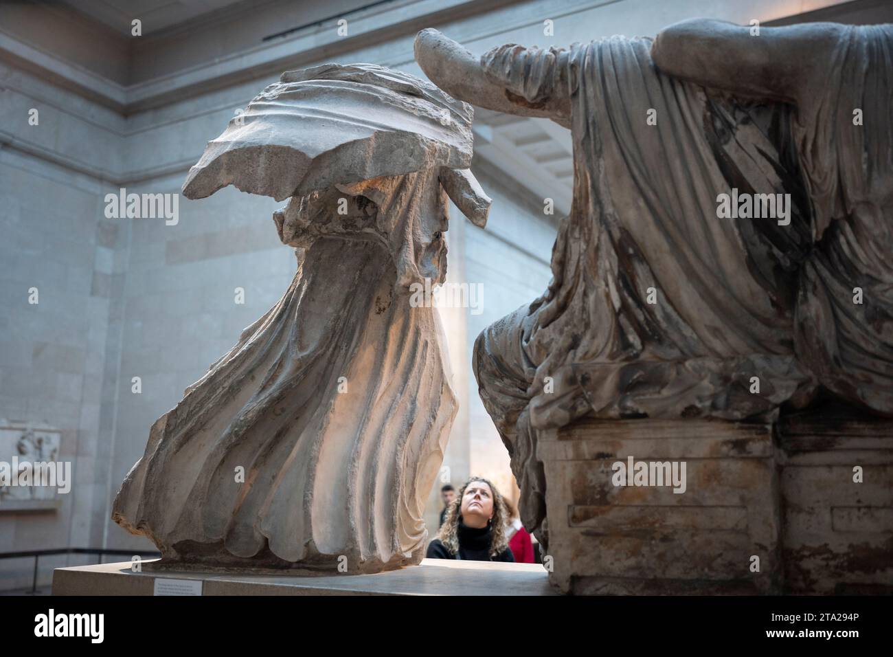 Visitors in London's British Museum admire the horse's head, one of the ...