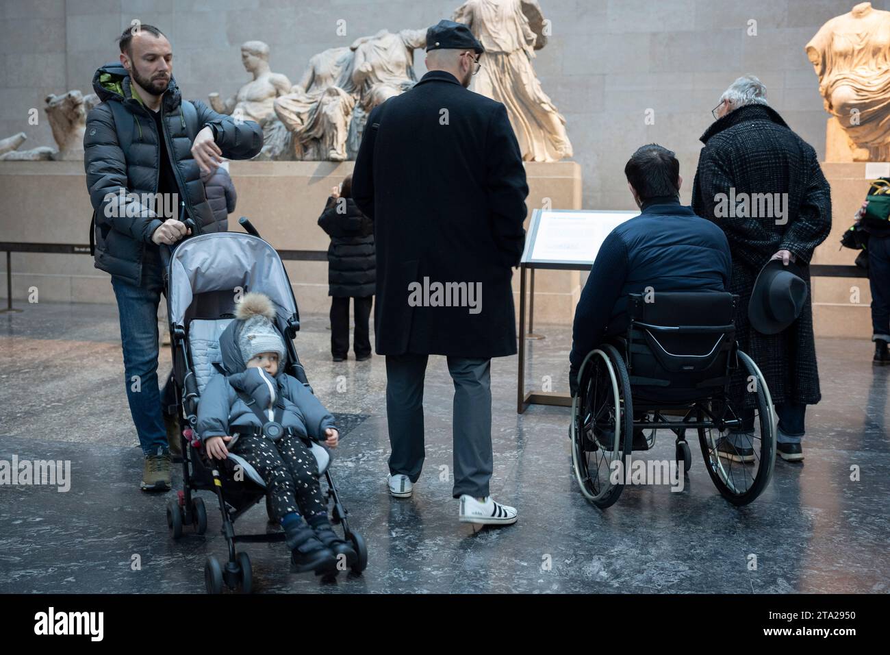 Visitors in London's British Museum admire the horse's head, one of the ...