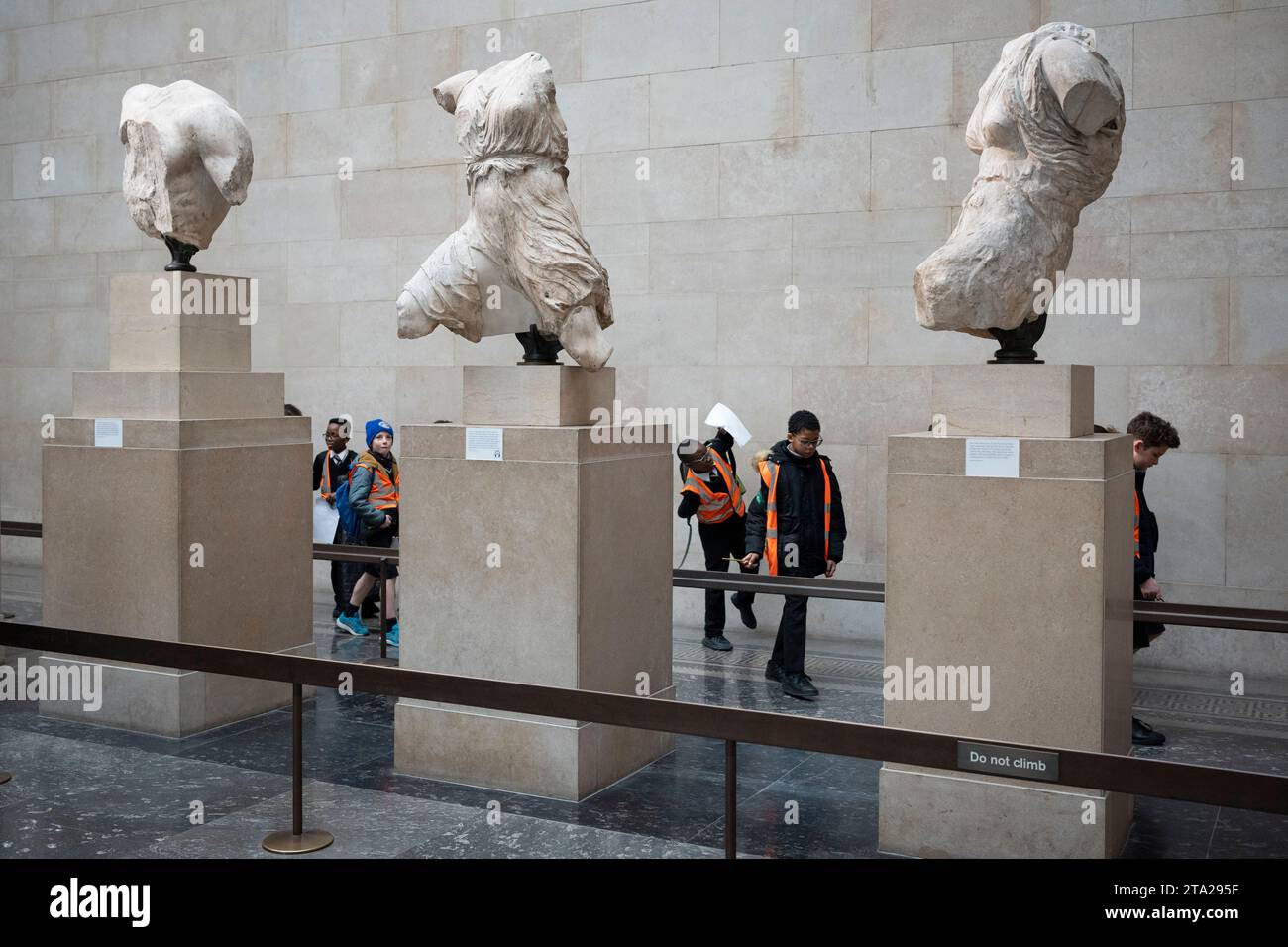 Visitors in London's British Museum admire the horse's head, one of the ...