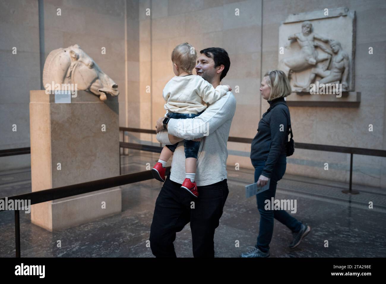 Visitors in London's British Museum admire the horse's head, one of the ...