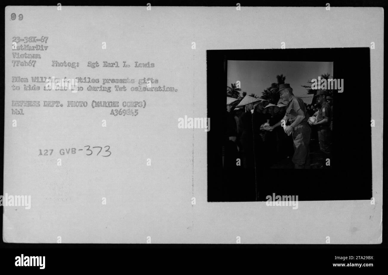 Sergeant William A. Stiles presents gifts to children in Duc Pho during ...