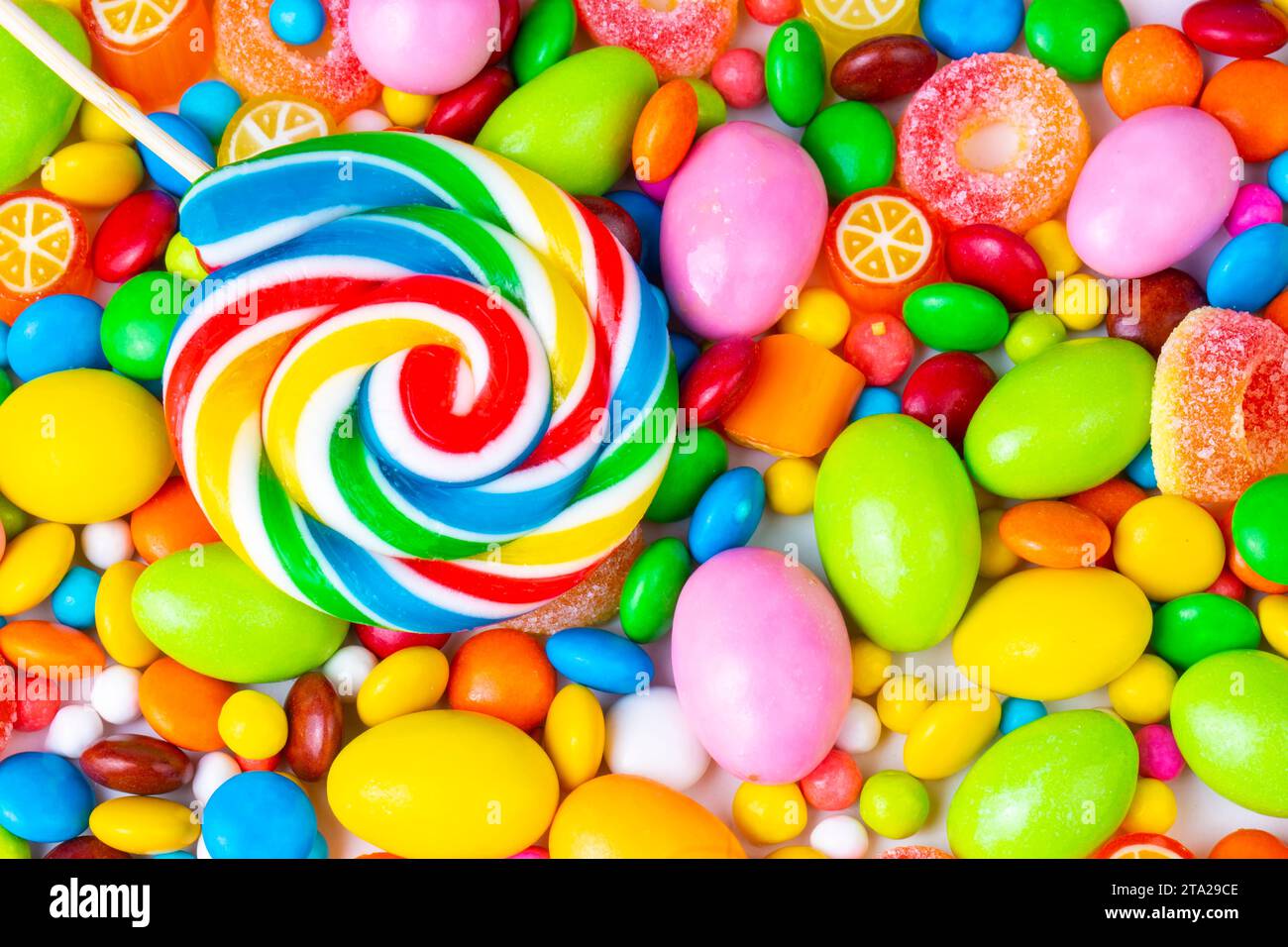 Colorful lollipops and different colored round candy. Top view Stock ...
