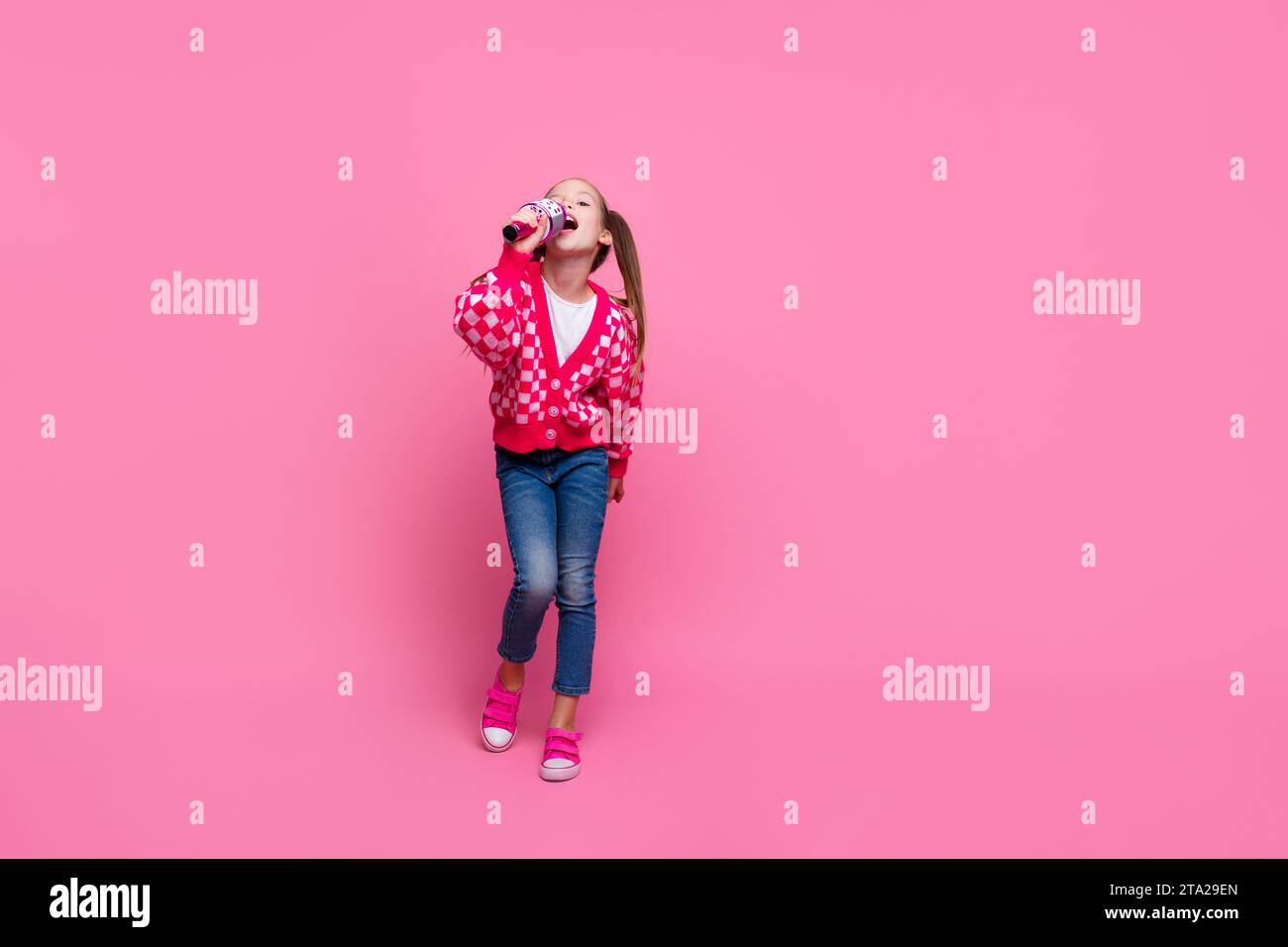 Full length photo of cheerful girl with ponytails dressed cardigan sing ...
