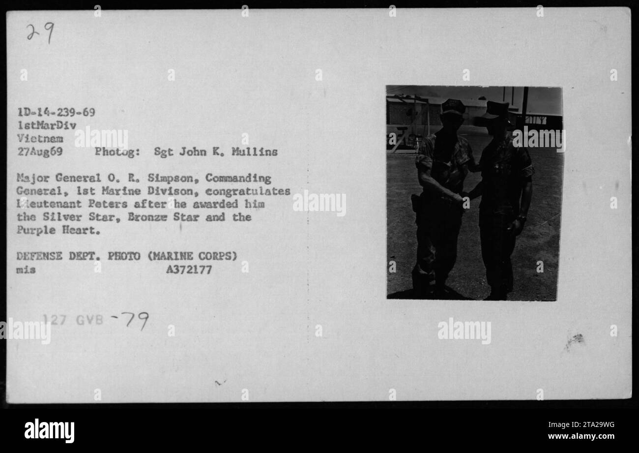 Major General O.R. Simpson congratulates Lieutenant Peters after ...