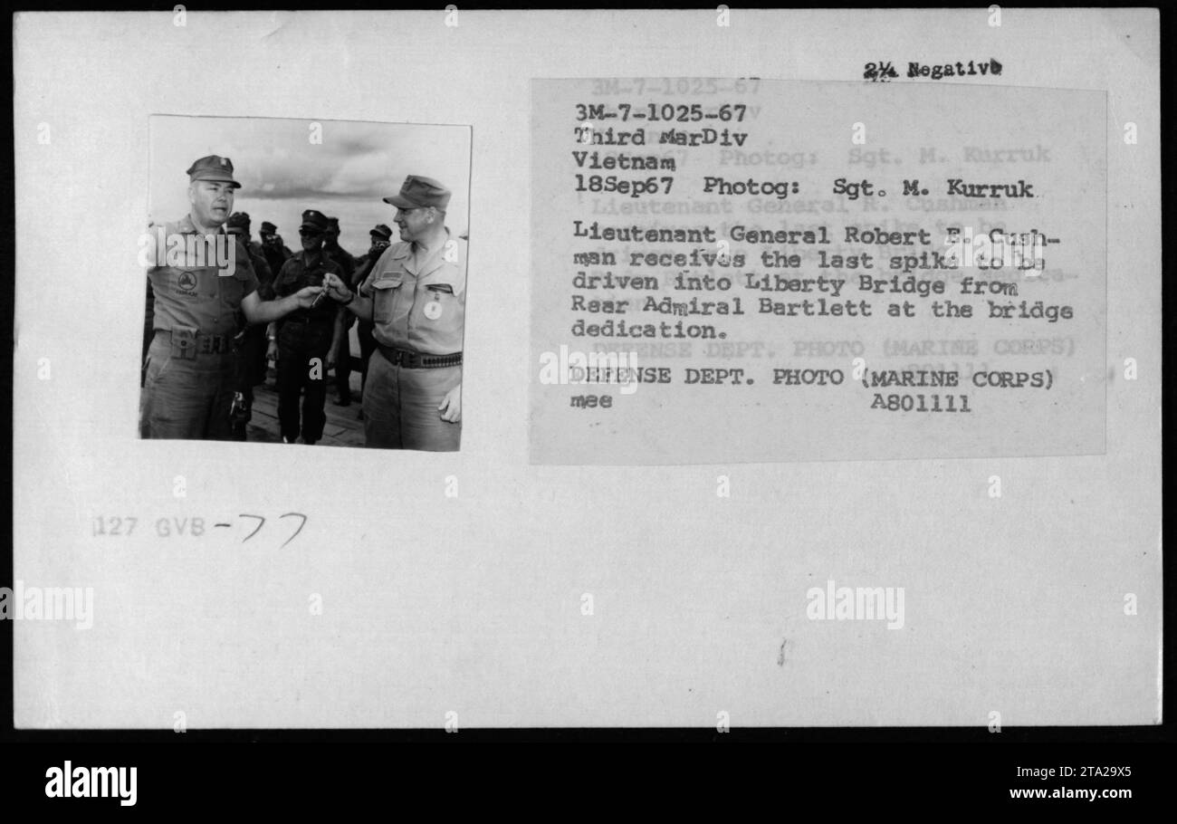 Lieutenant General Robert E. Cushman receives the last spike to be ...