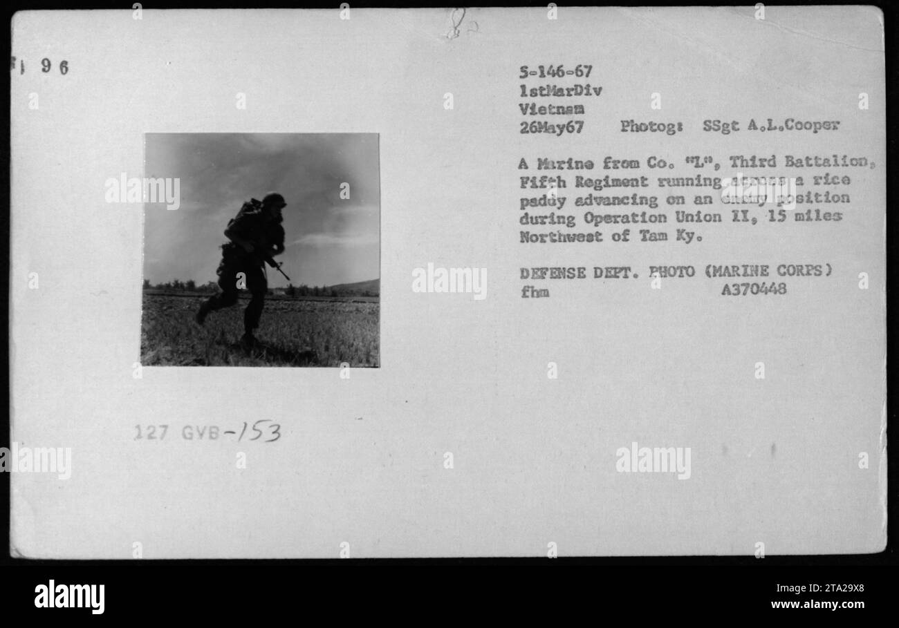 A Marine from Co. "L", Third Battalion, Fifth Regiment running across a ...