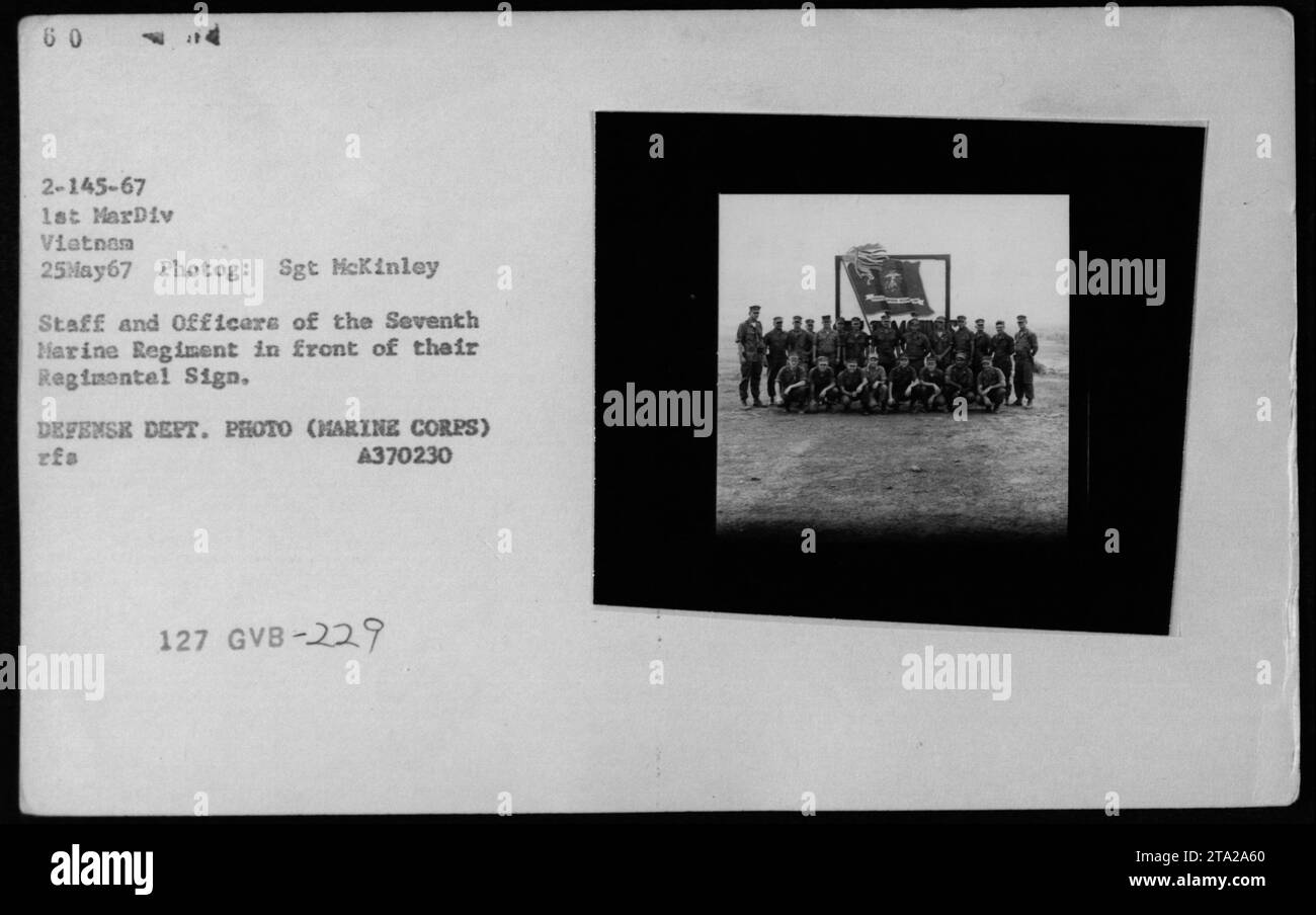 Staff and officers of the Seventh Marine Regiment posing in front of their regimental sign ...