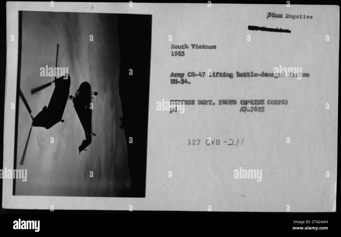 A U.S. Army CH-47 helicopter lifts a battle-damaged Marine UH-34 ...