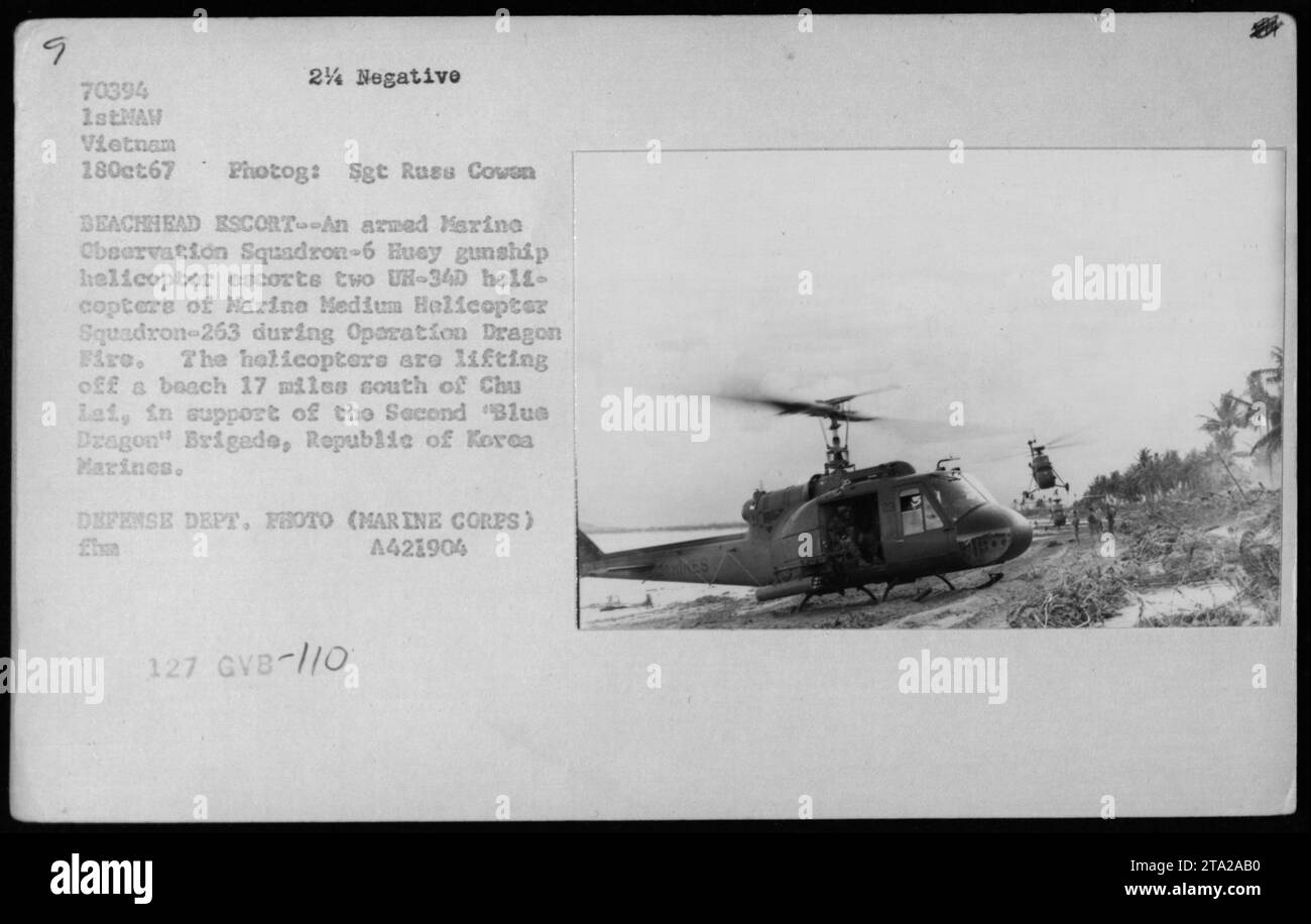 A Marine Observation Squadron-6 Huey gunship escorts two UH-34D ...