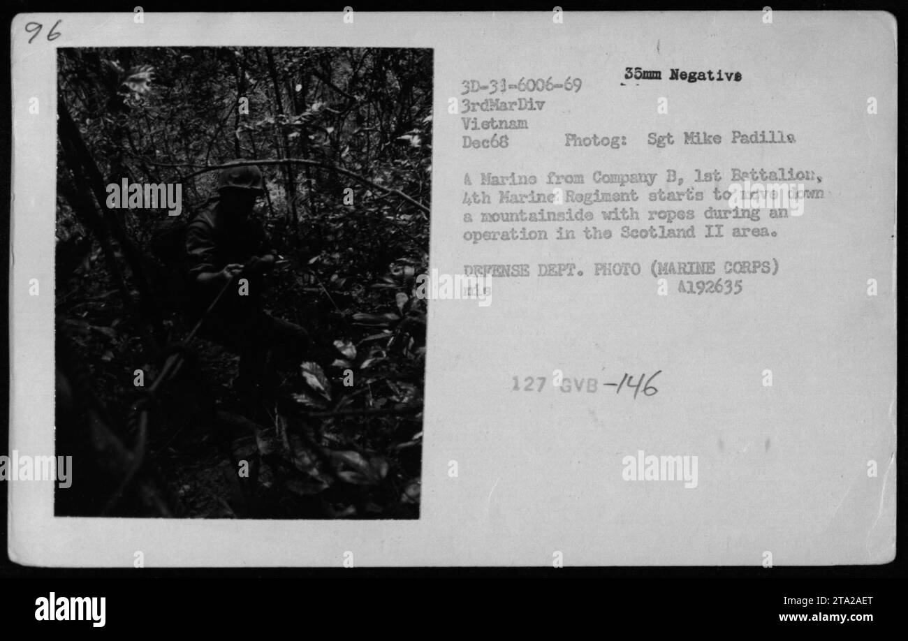 A marine from Company B, 1st Battalion, 4th Marine Regiment descends a ...