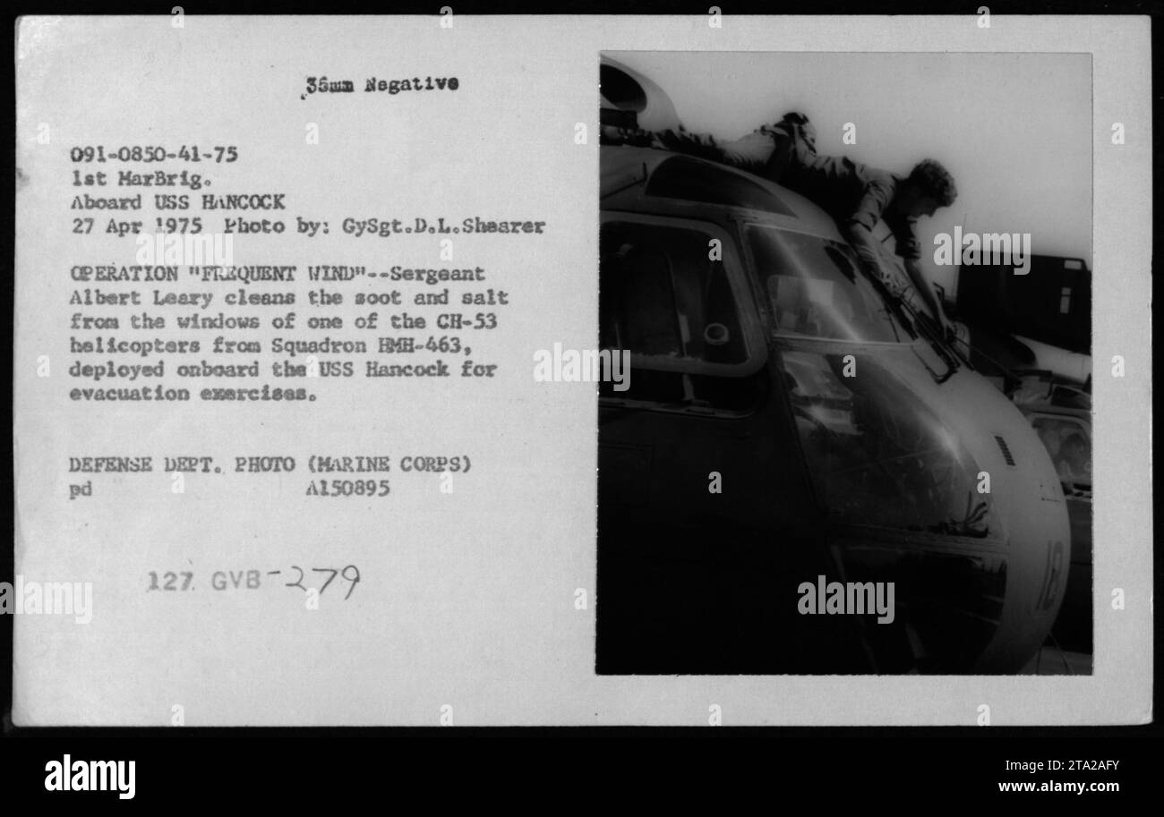 "Sergeant Albert Leary seen cleaning the windows of a CH-53 helicopter ...