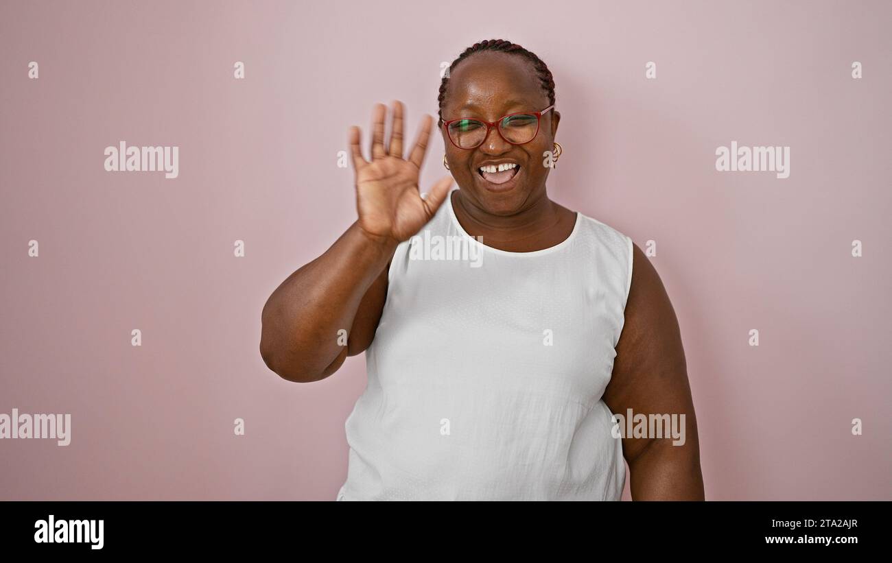 Confident african american woman joyfully saying hello, smiling over ...