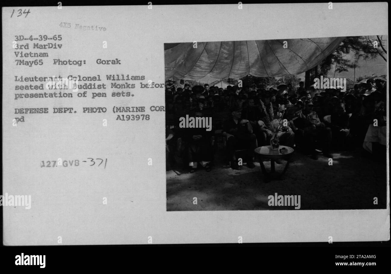 Lieutenant Colonel Williams is seen seated with Buddhist monks before ...