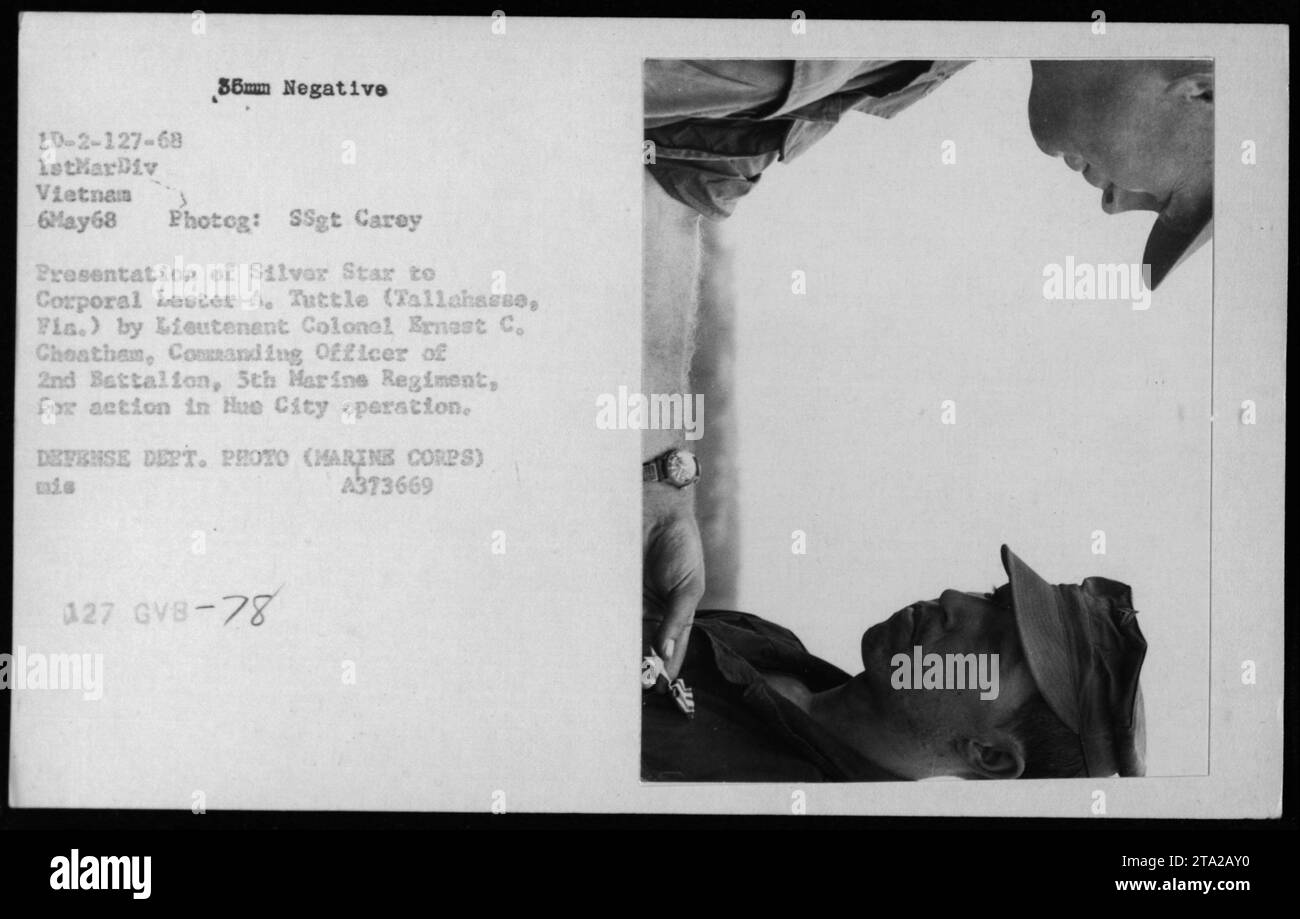 Lieutenant Colonel Ernest C. Cheathan presents Corporal Lester A. Tuttle with the Silver Star ...