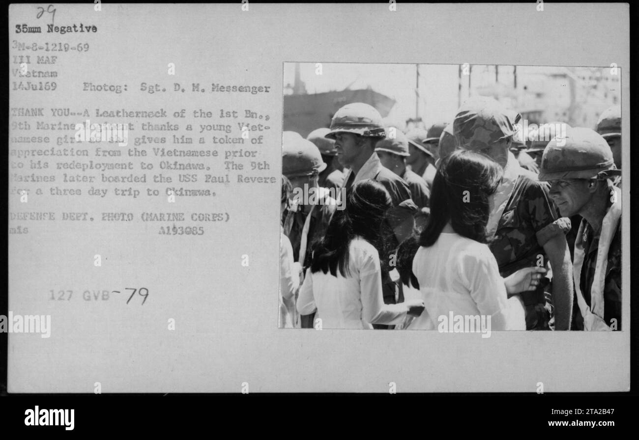 A Marine Corps servicemember receives a token of appreciation from a ...
