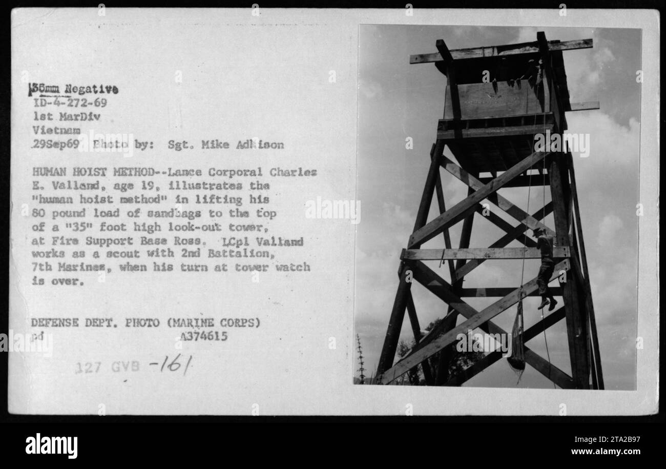 Lance Corporal Charles E. Valland lifts an 80-pound load of sandbags to ...